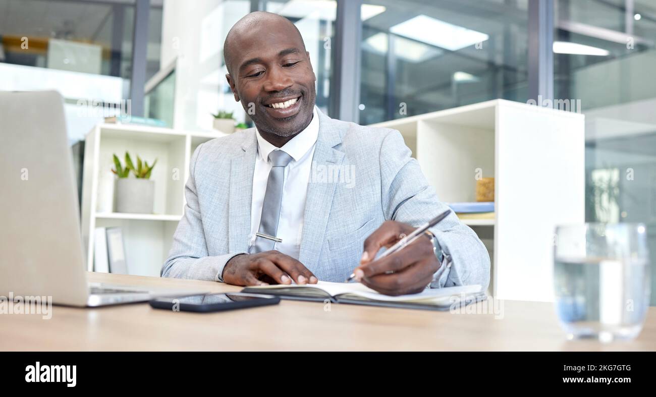 Black man, business and writing notes, laptop planning and internet ...