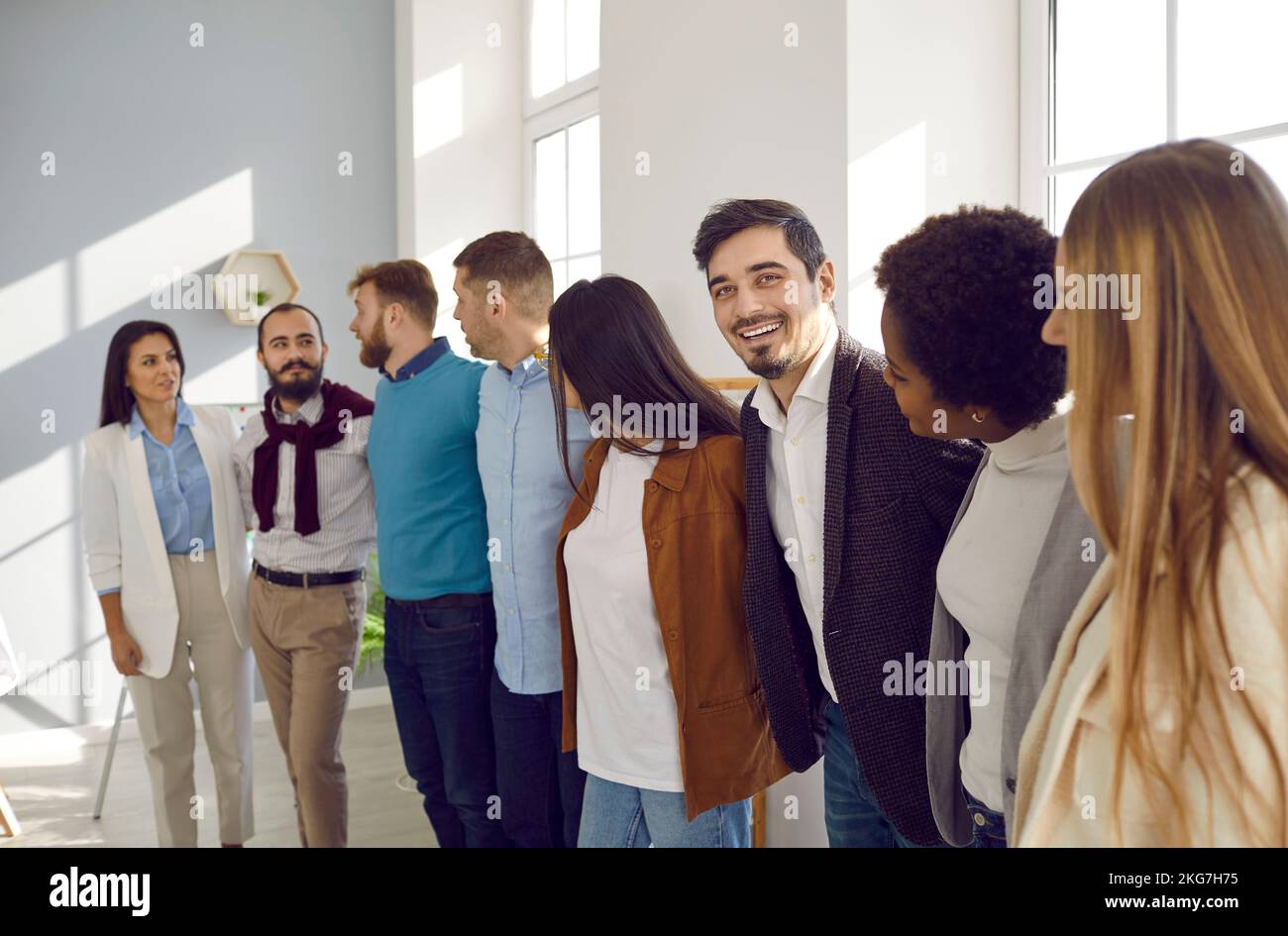 Multiracial team of happy supportive business people hugging, smiling ...
