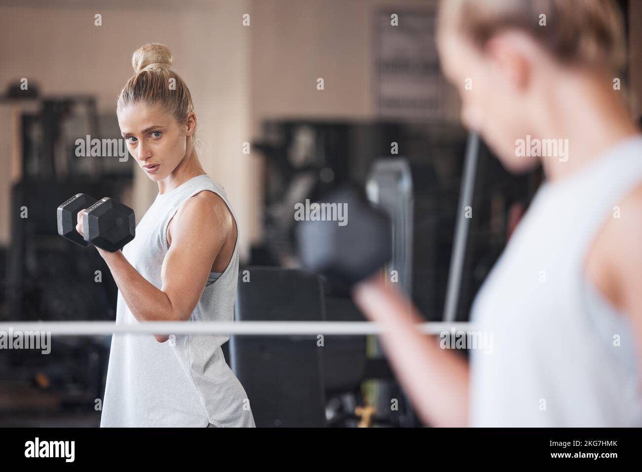 Fitness, dumbbell and woman bodybuilder, weightlifting in gym, mirror ...