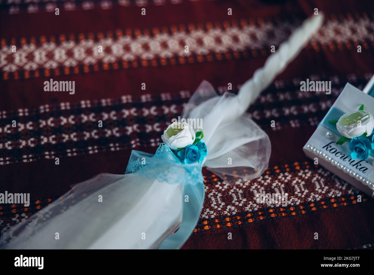 White candle with an angel prepared for a baby orthodox baptism in ...
