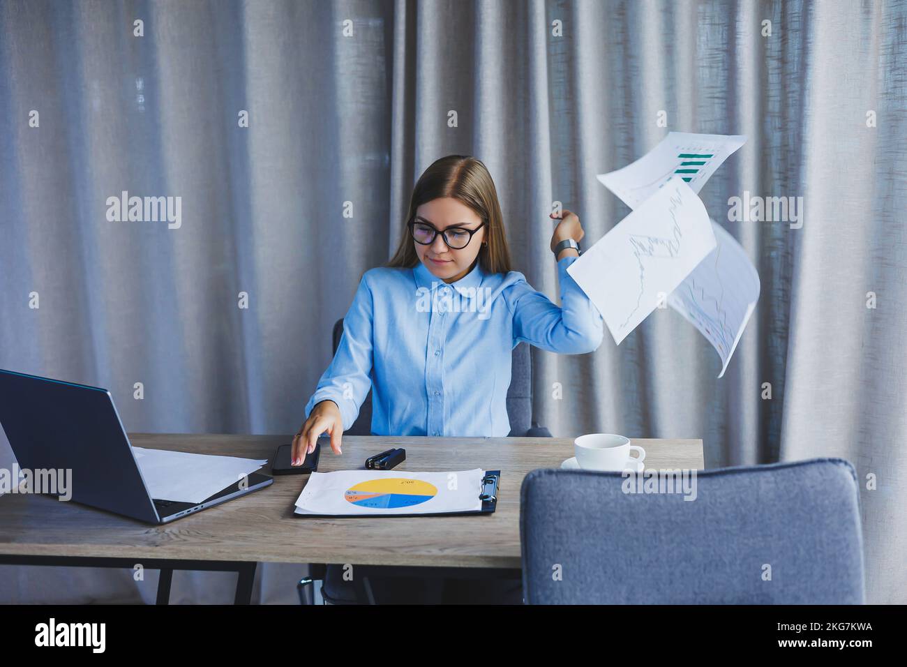 A woman manager is going crazy at her desk and throwing documents. Hard ...