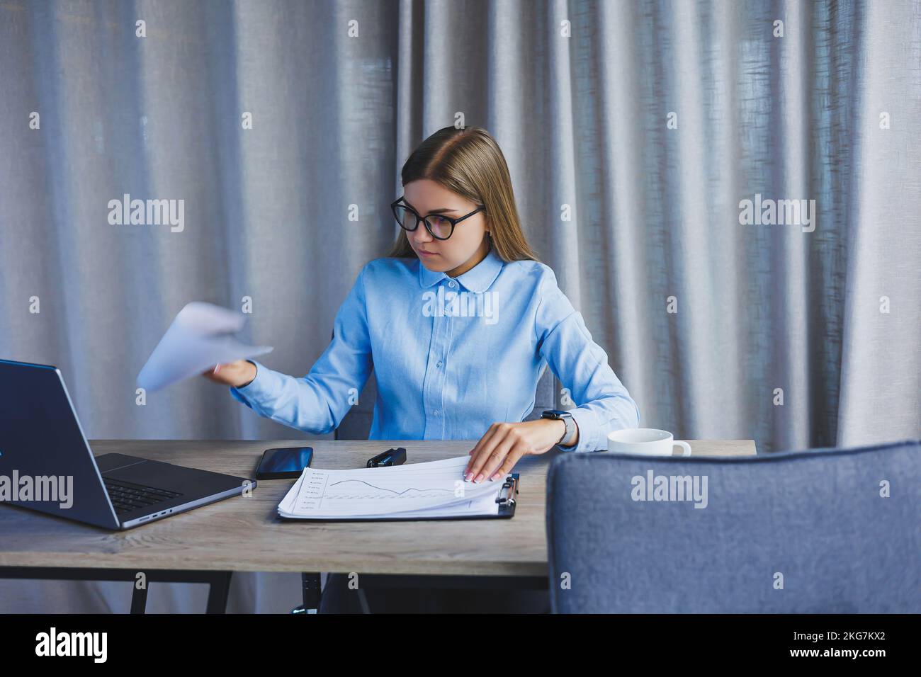 A woman manager is going crazy at her desk and throwing documents. Hard ...