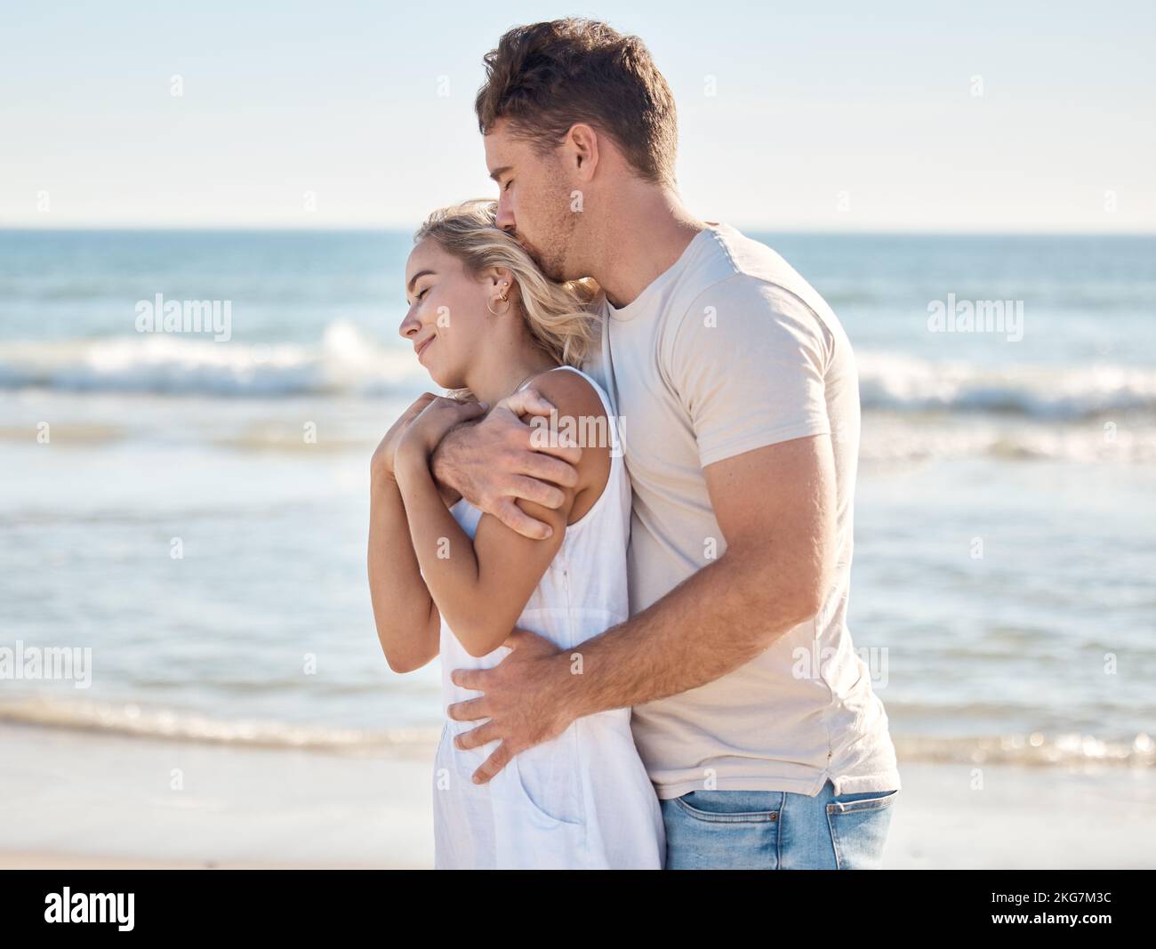 Beach, happy and couple hugging with love, care and romance while on a ...