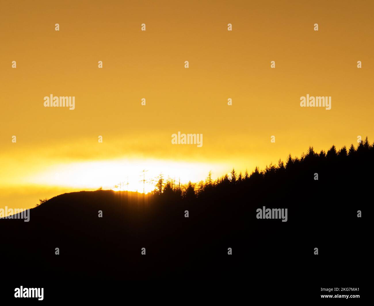 The sun setting over Black fell from Ambleside, Lake District, UK Stock ...