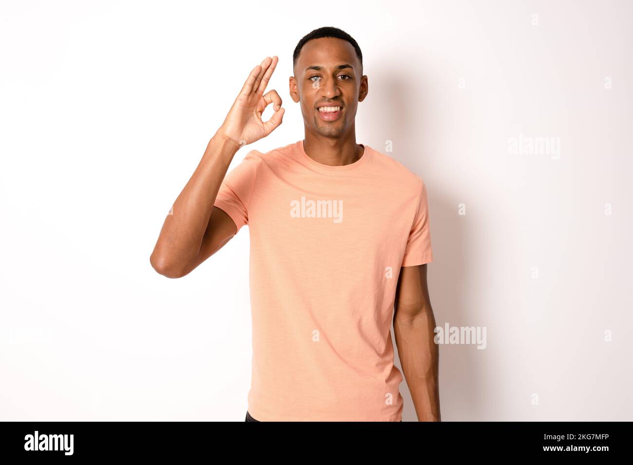 Young handsome man over isolated white background showing okay sign ...
