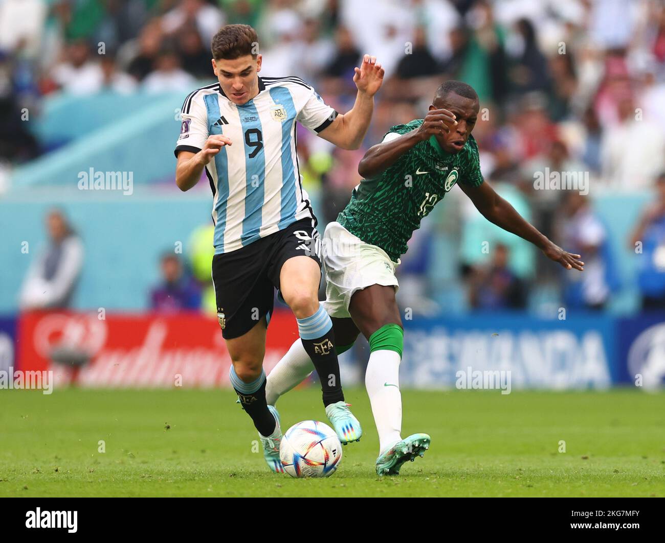 Doha, Qatar. 22nd Nov, 2022. Julian Alvarez of Argentina tussles with ...