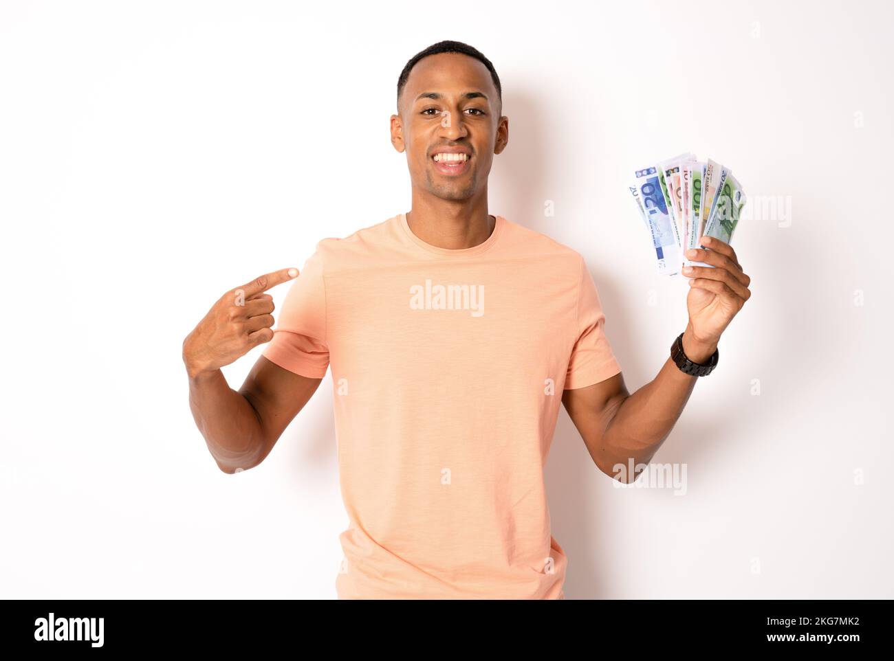 Young man with money standing isolated over white background Stock ...