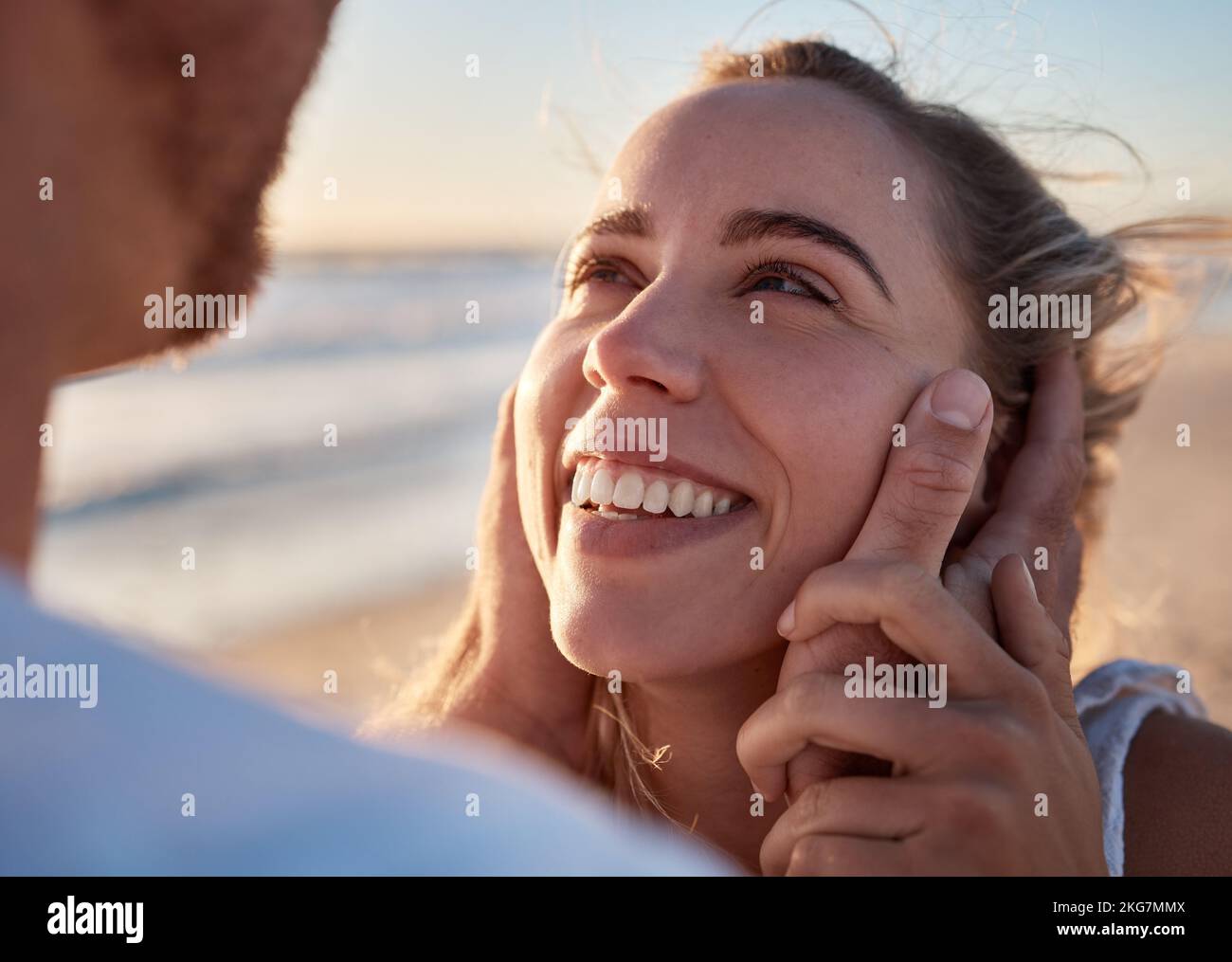 Face in hands, couple and love with trust and care, travel to beach on ...