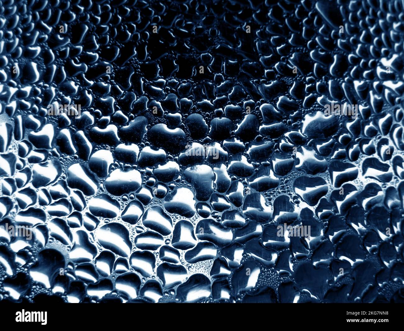 Glass with raindrops on blue tone background. Abstract ultramarine wet ...