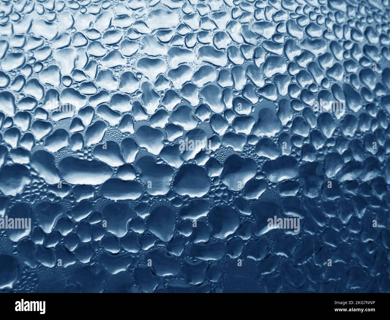 Glass with raindrops on blue tone background. Abstract ultramarine wet ...