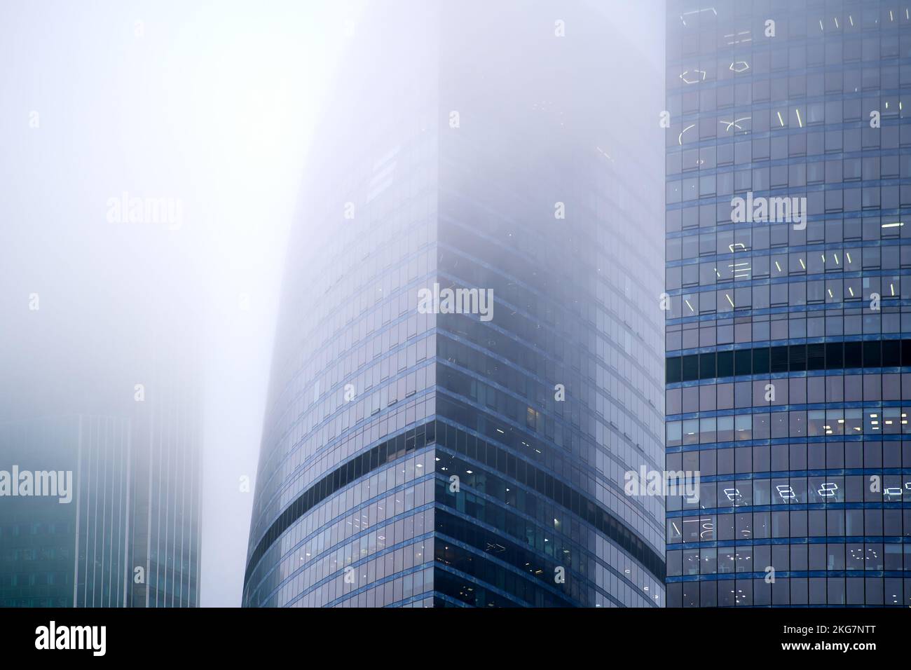 Windows of skyscrapers in the fog, background copy space. Metal ...