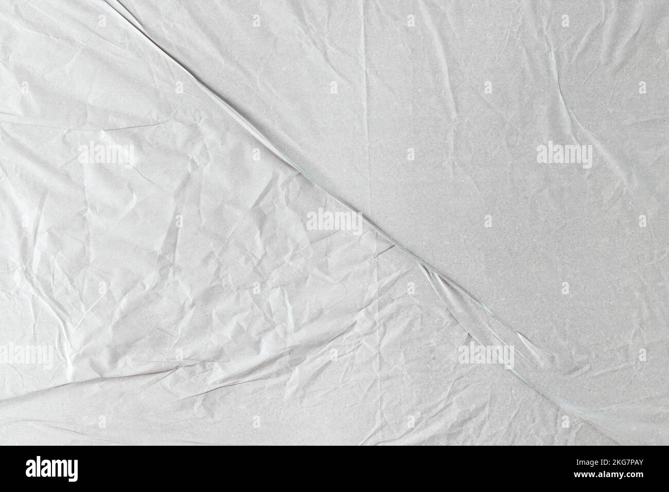 Corrugated piece of white paper on white background Stock Photo - Alamy