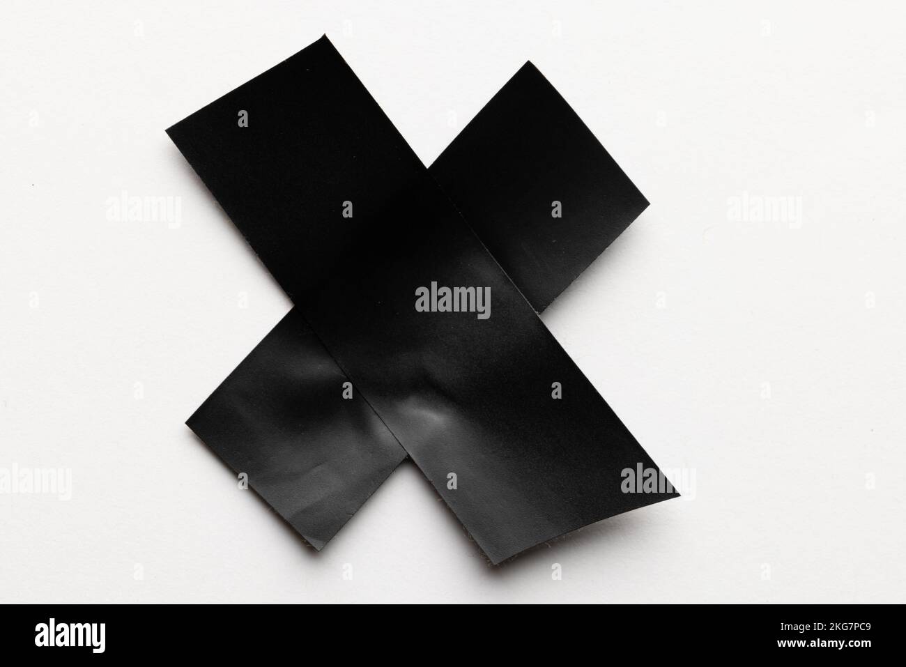 Cross shape black masking tape on white background Stock Photo - Alamy