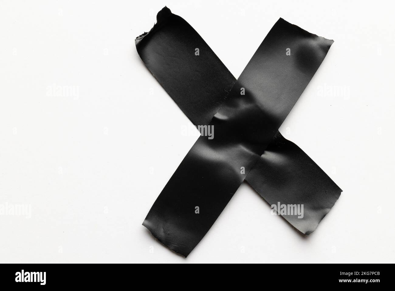 Cross shape black masking tape on white background Stock Photo - Alamy