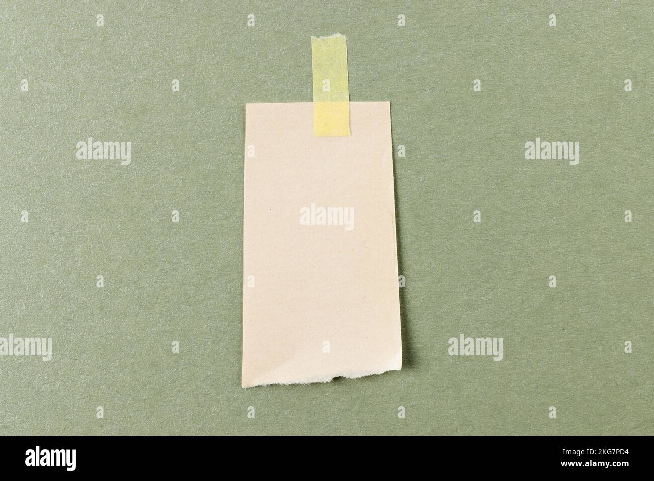 Ripped up piece of white paper with copy space on cardboard background ...