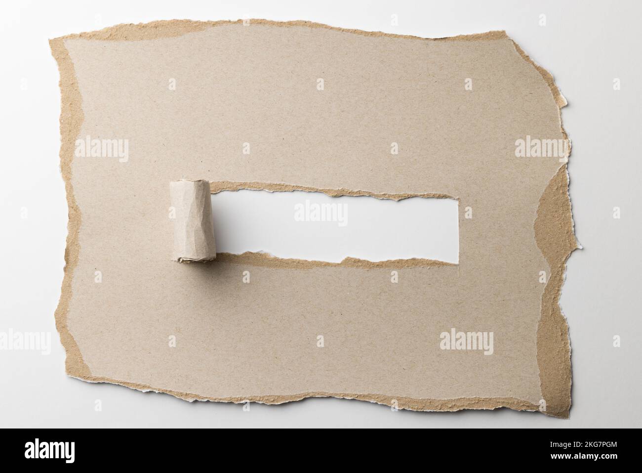 Ripped up piece of beige paper with copy space on white background ...