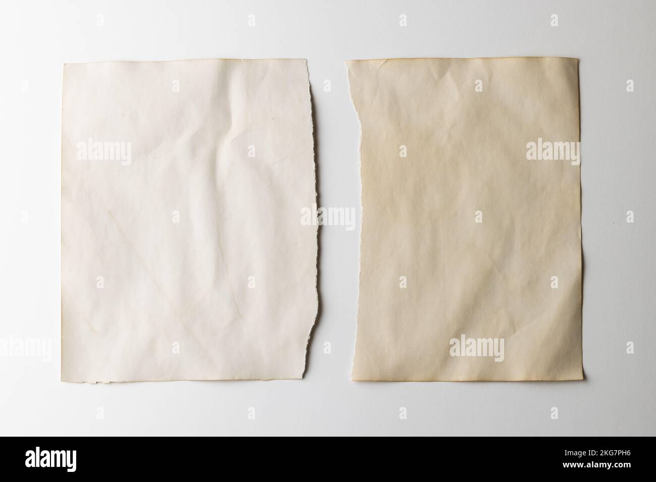Ripped up pieces of beige paper with copy space on white background ...