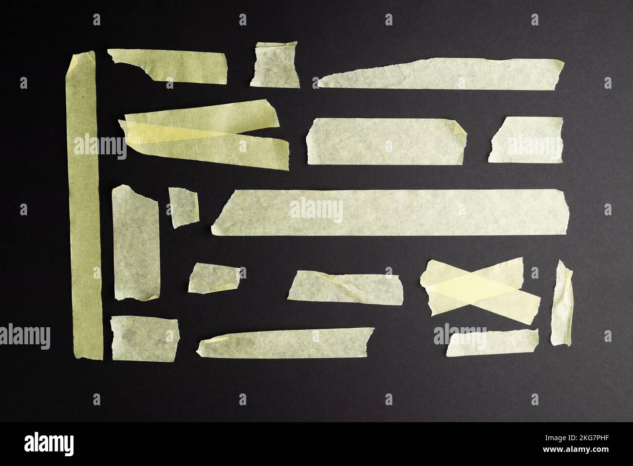 Ripped up pieces of masking tape with copy space on black background ...