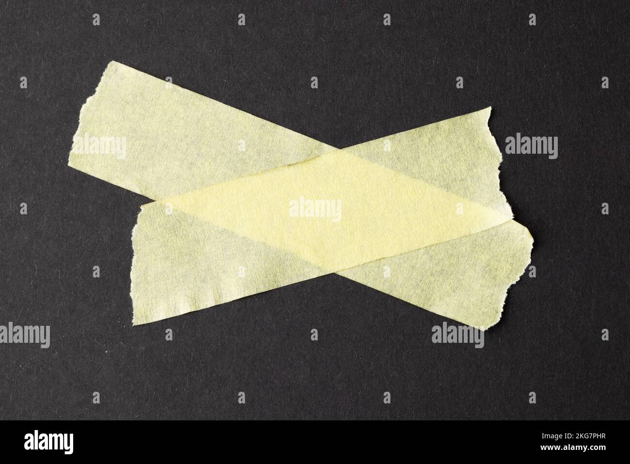 Ripped up pieces of masking tape with copy space on black background ...