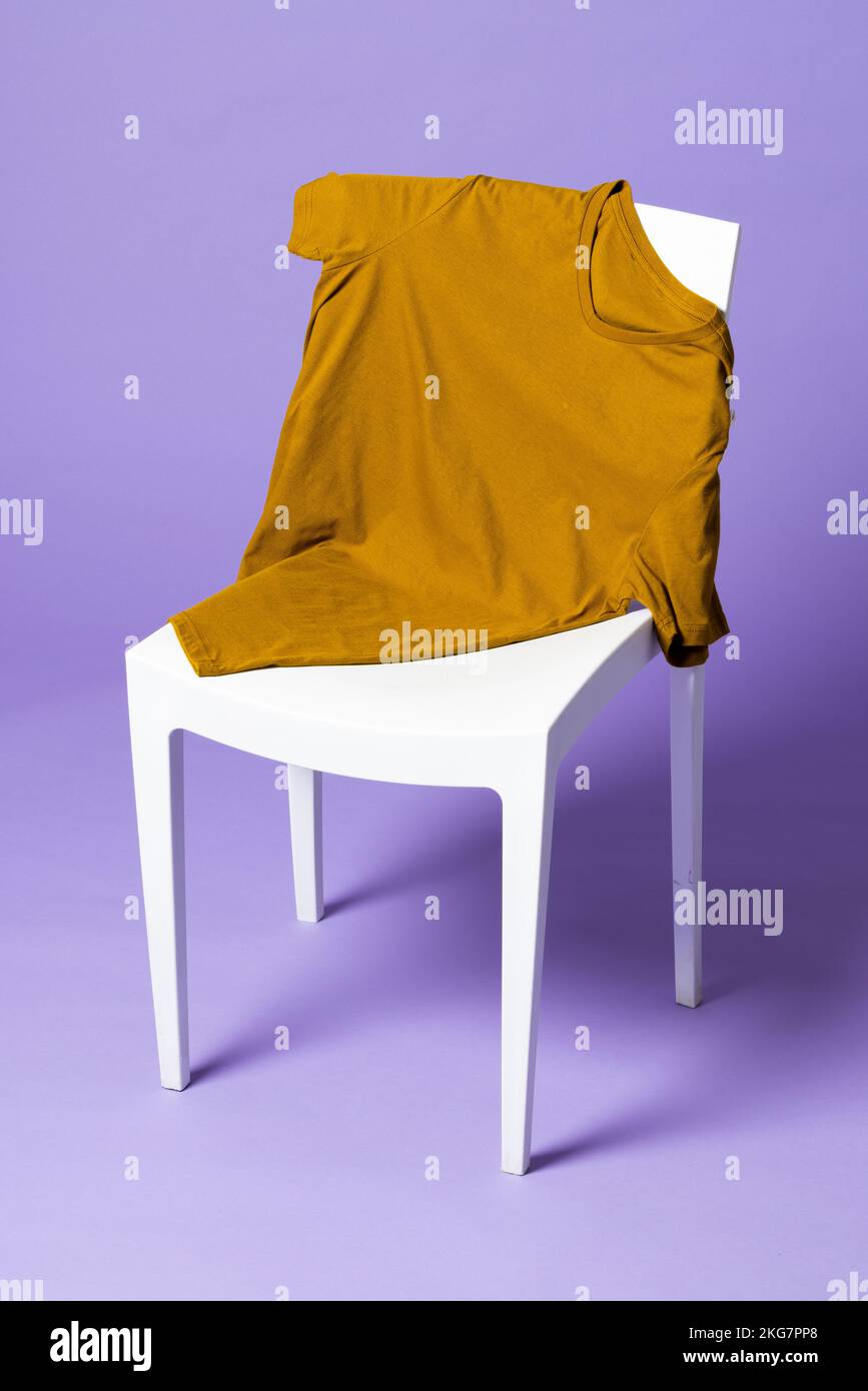 Tshirt displayed on chair and copy space on purple background Stock ...