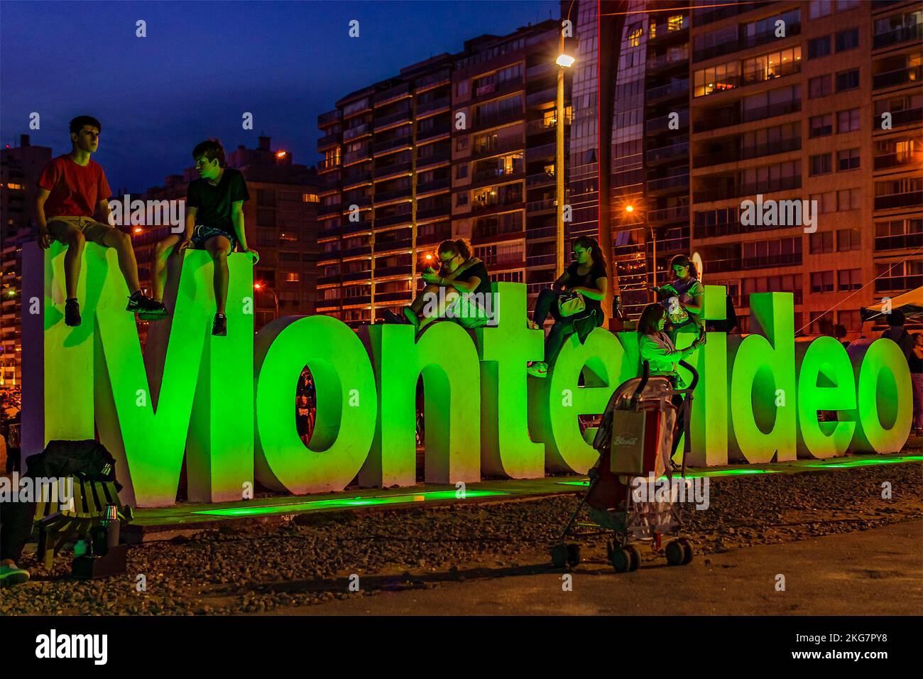 MONTEVIDEO, URUGUAY, NOVEMBER - 2022 - Urban night scene people posing ...