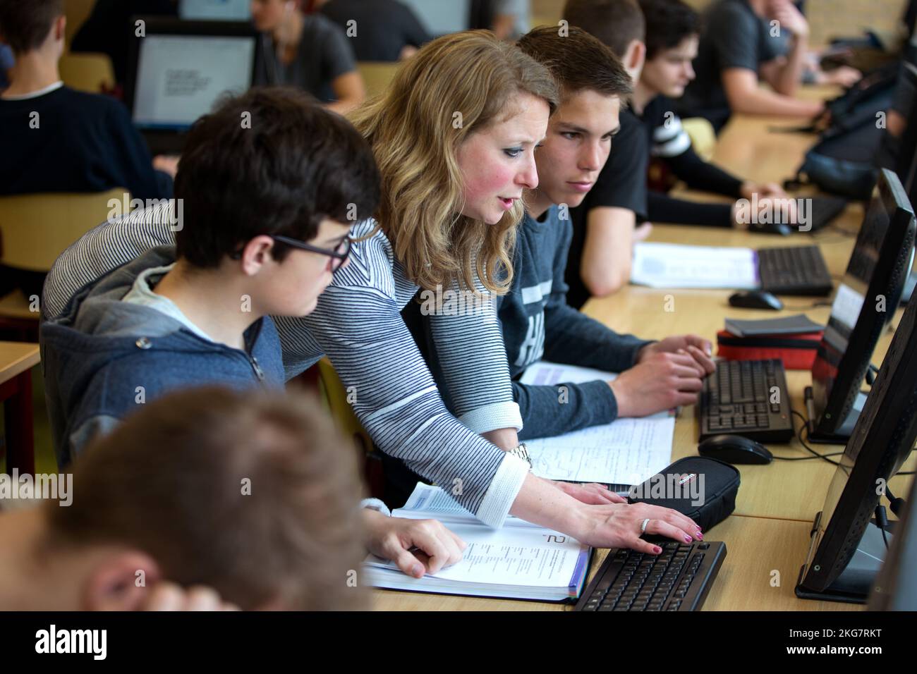 Teacher with students in a classroom in a secondary school. Holland ...