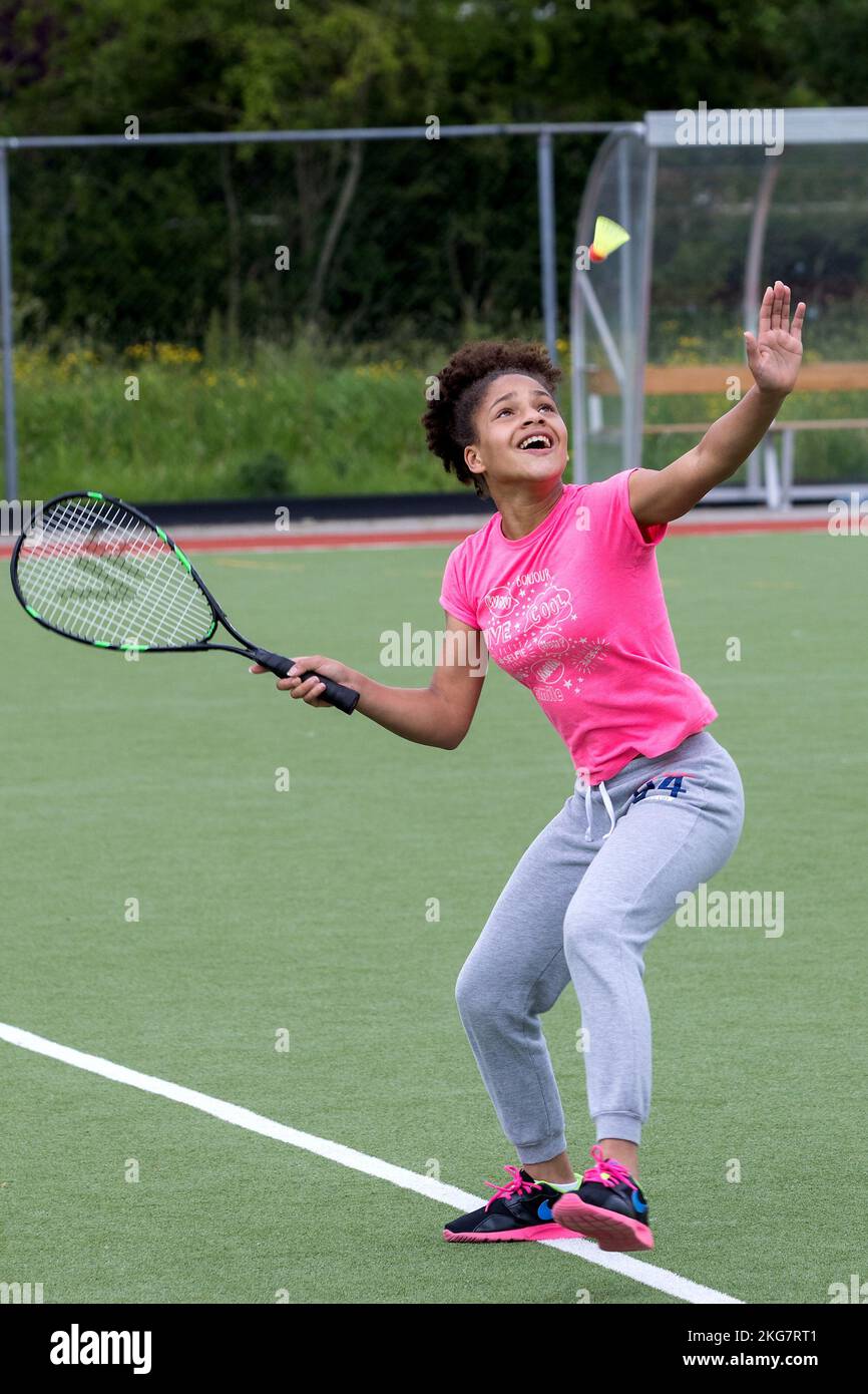 secondary school students plays badminton on the school sports field ...