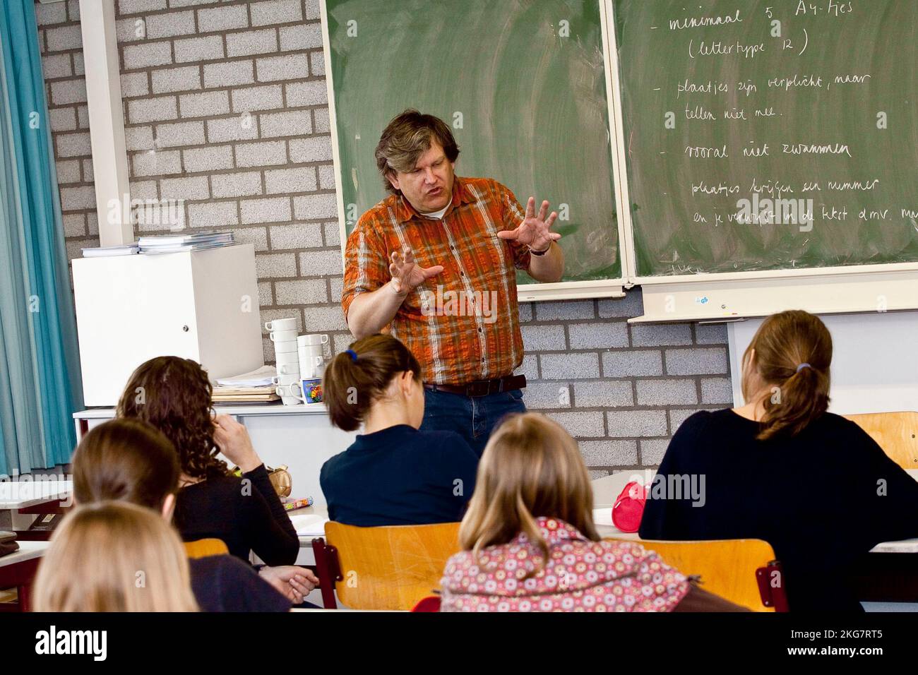 Teacher with students in a classroom in a secondary school. Holland ...