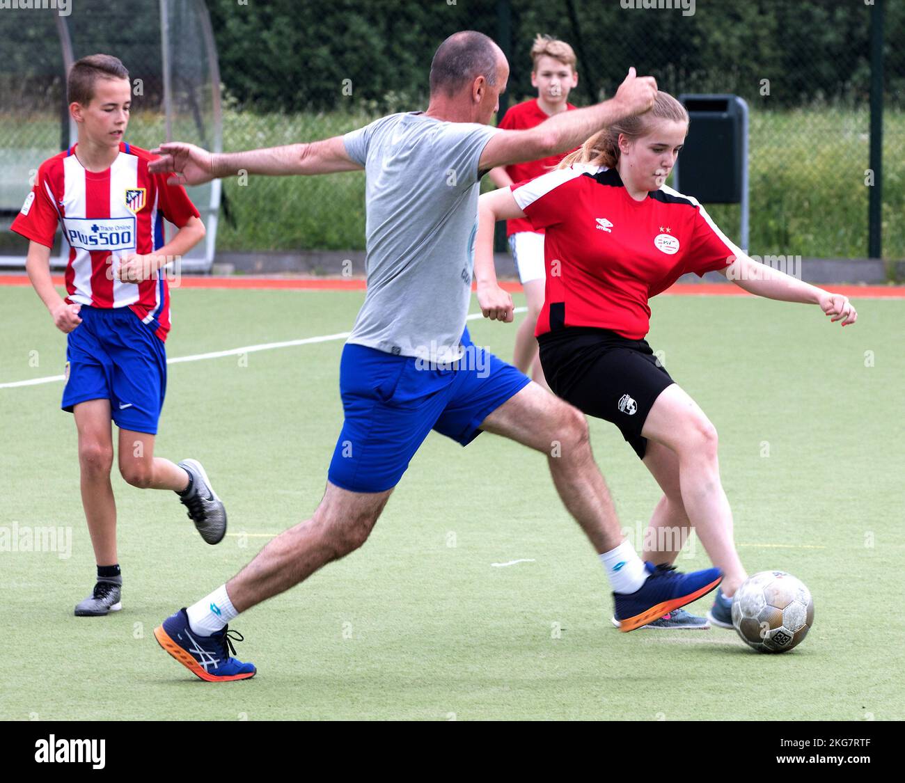 secondary school students plays soccer on the school sports field ...