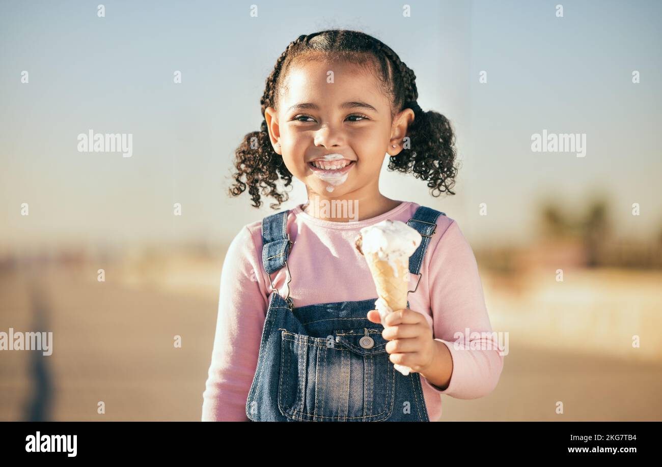 Girl, child and eating ice cream in city, street or urban road outdoors ...