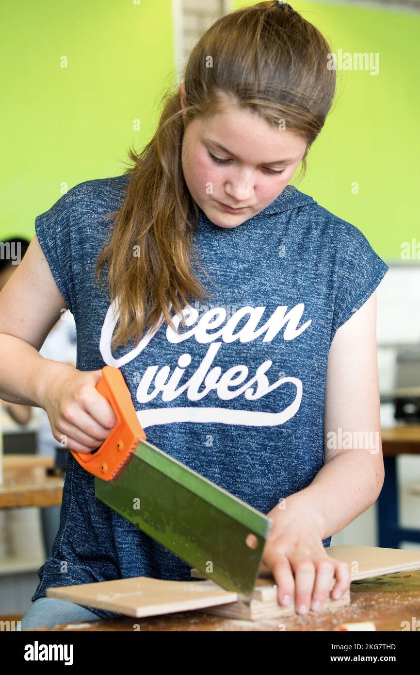 secondary school student saws wood in the workshop holland vvbvanbree ...