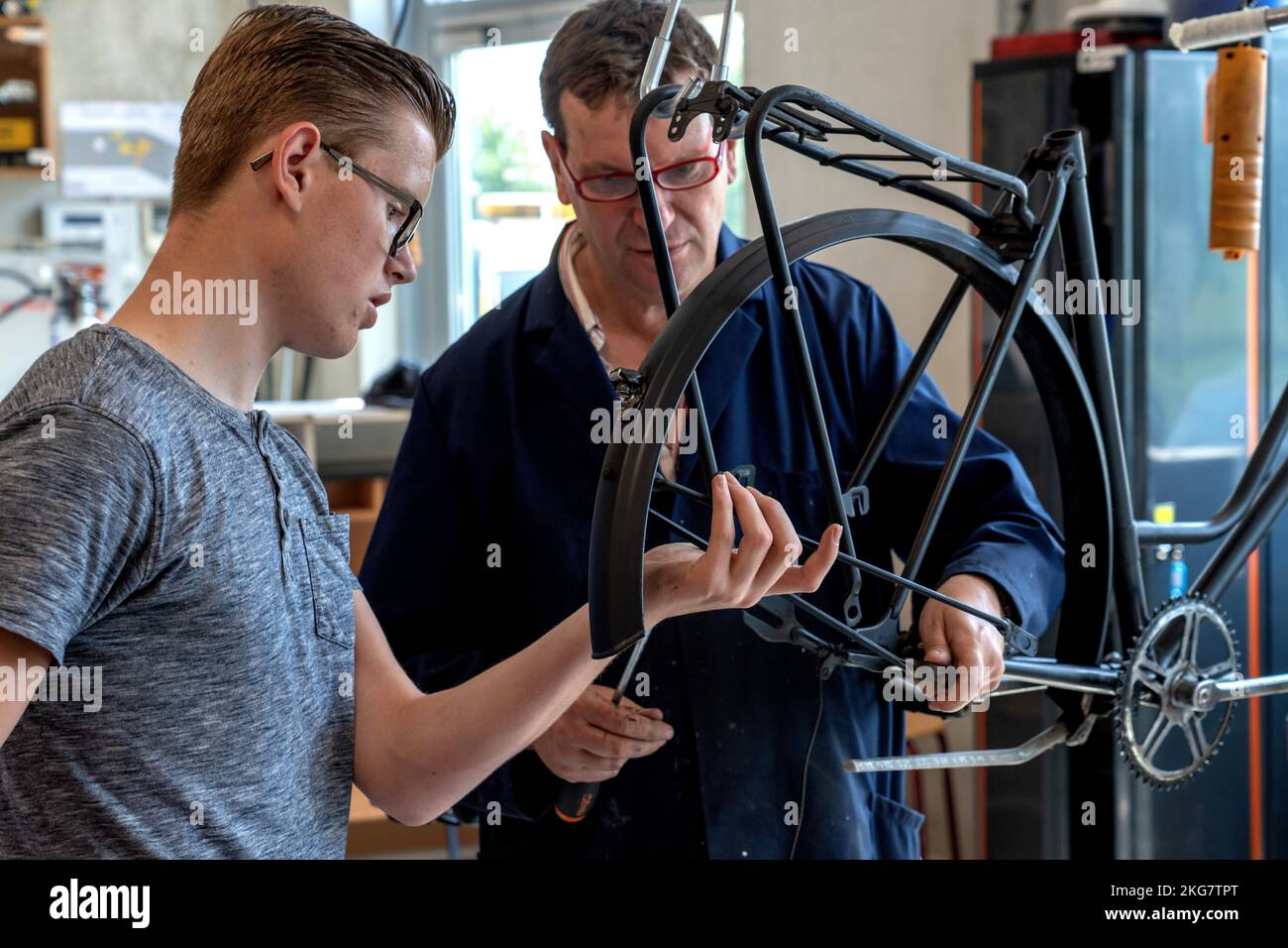 secondary school student and teacher working with a bicycle, 2018 ...