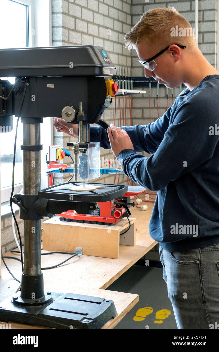 Students working with a drill in the technasium of a secondary school ...