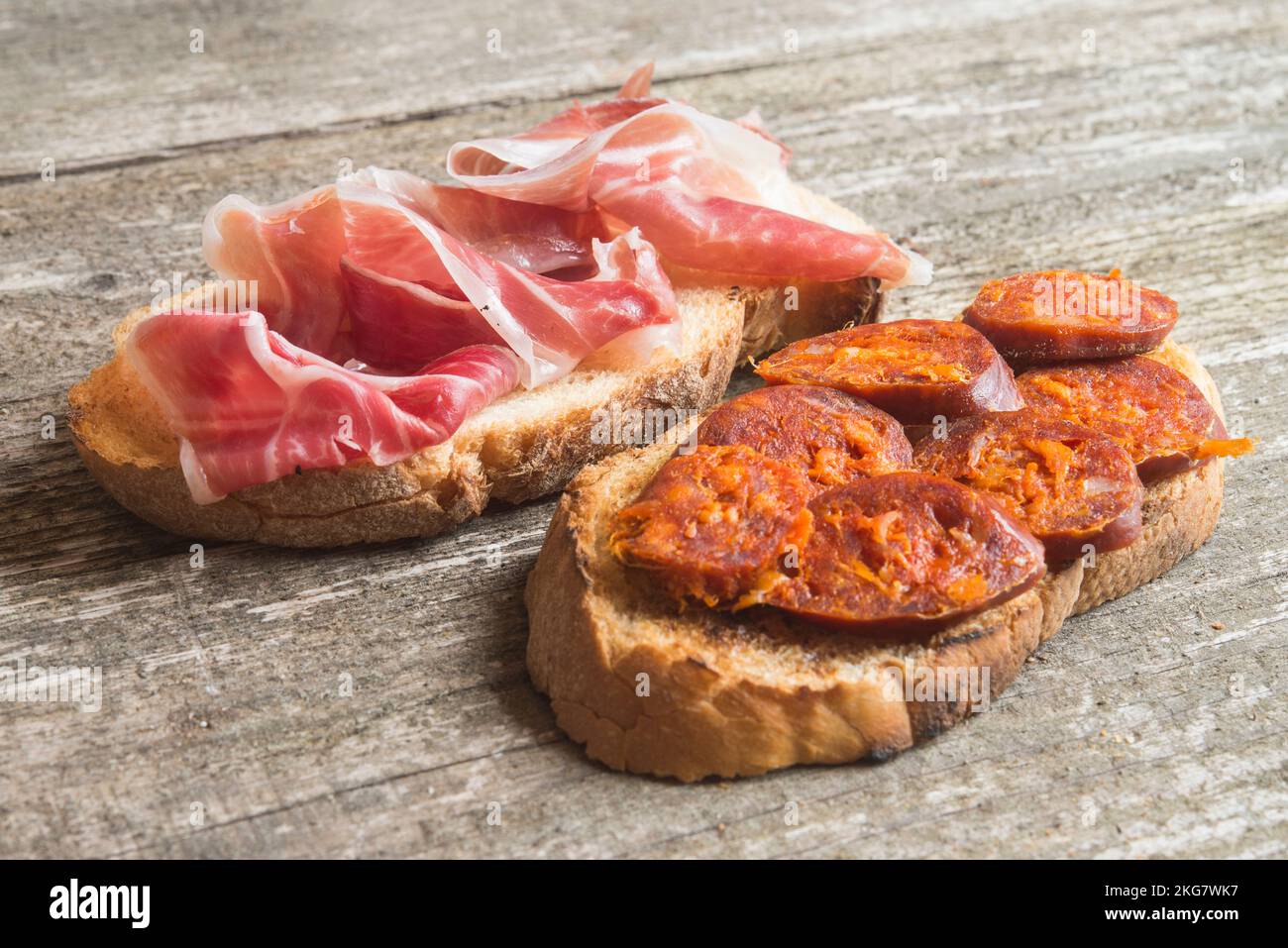 bread toast with chorizo and ham (spanish tapa Stock Photo - Alamy