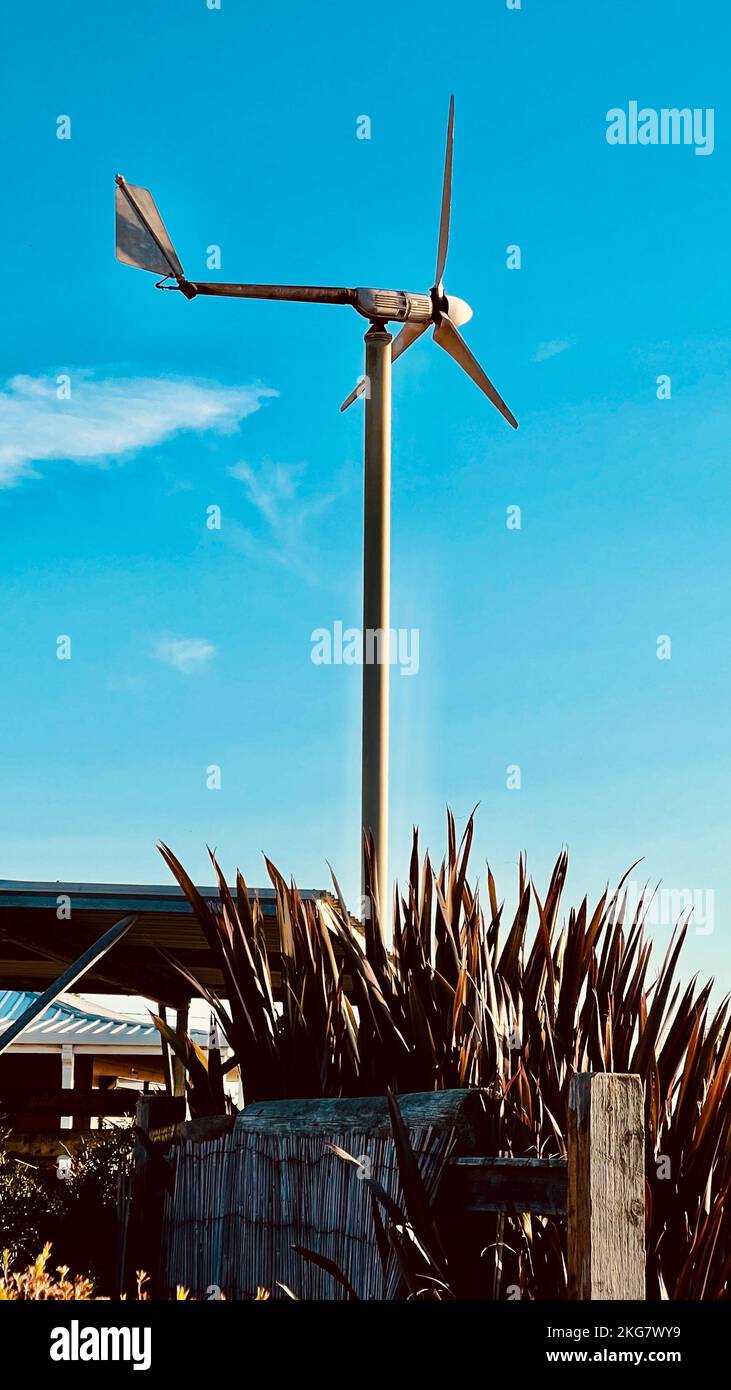 A farm with a wind rotating machine on it Stock Photo - Alamy