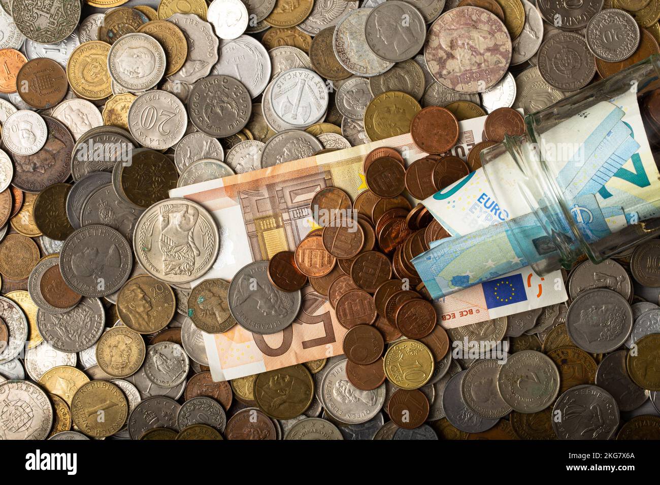 Old coins and modern on euro banknotes Stock Photo - Alamy