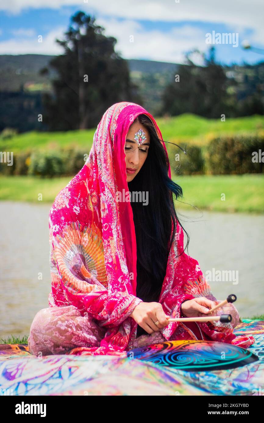 A vertical of an attractive Colombian girl playing a traditional ...