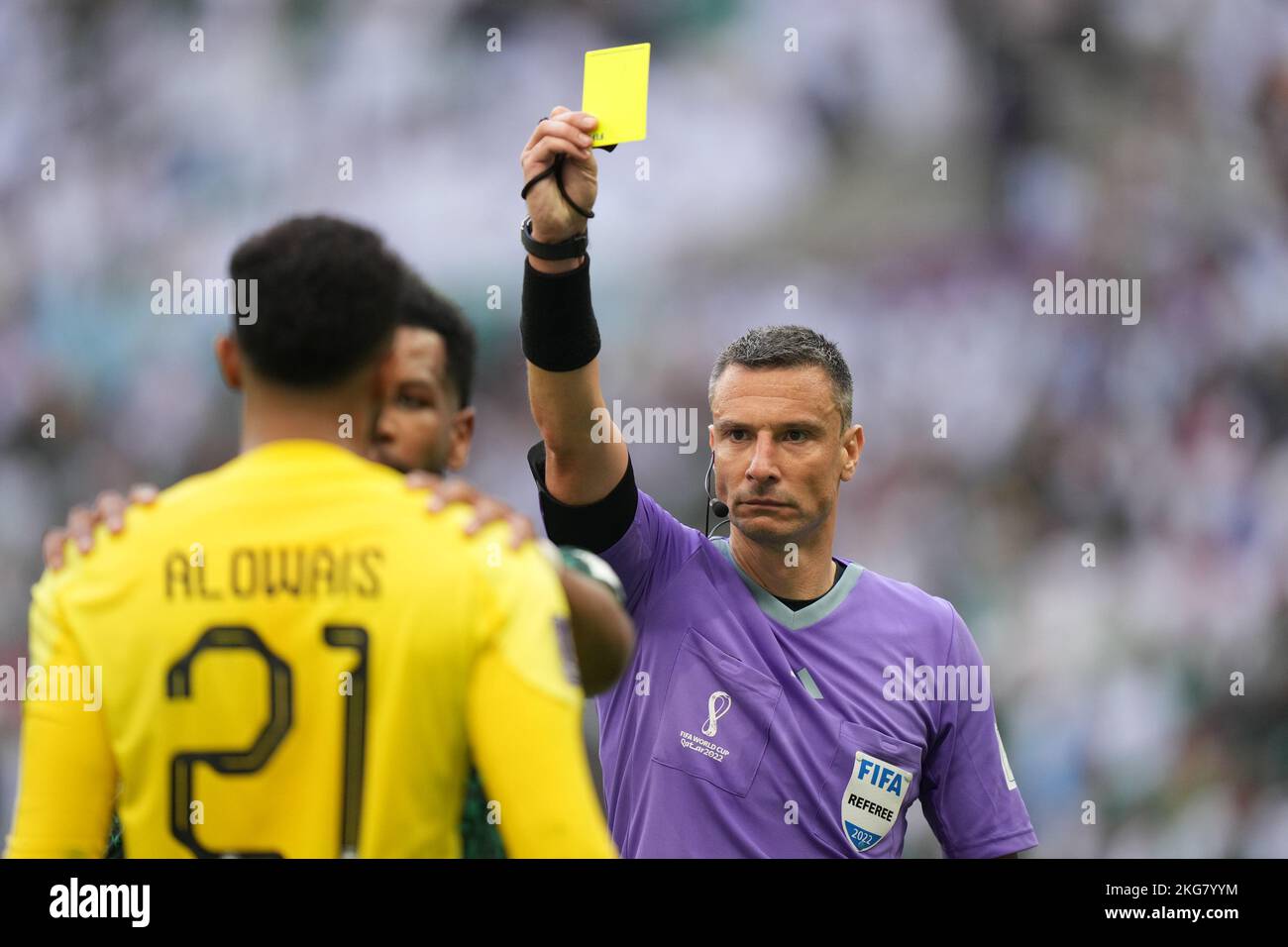 Te referee shows yellow card to Alowais Mohammed of Saudi Arabia during the Qatar 2022 World Cup ...