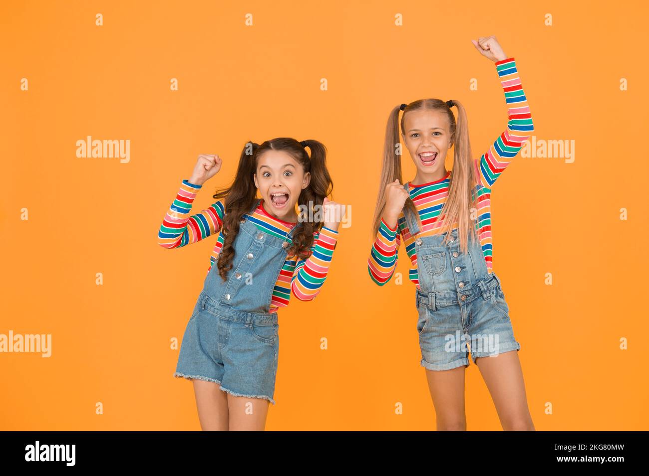 got great style. small sisters have fun. little girls yellow background ...