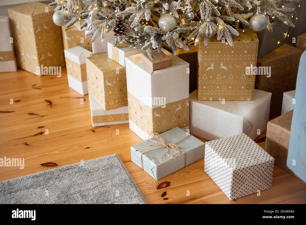 Wooden floor, laminate, boxes with gifts in white craft gold paper ...