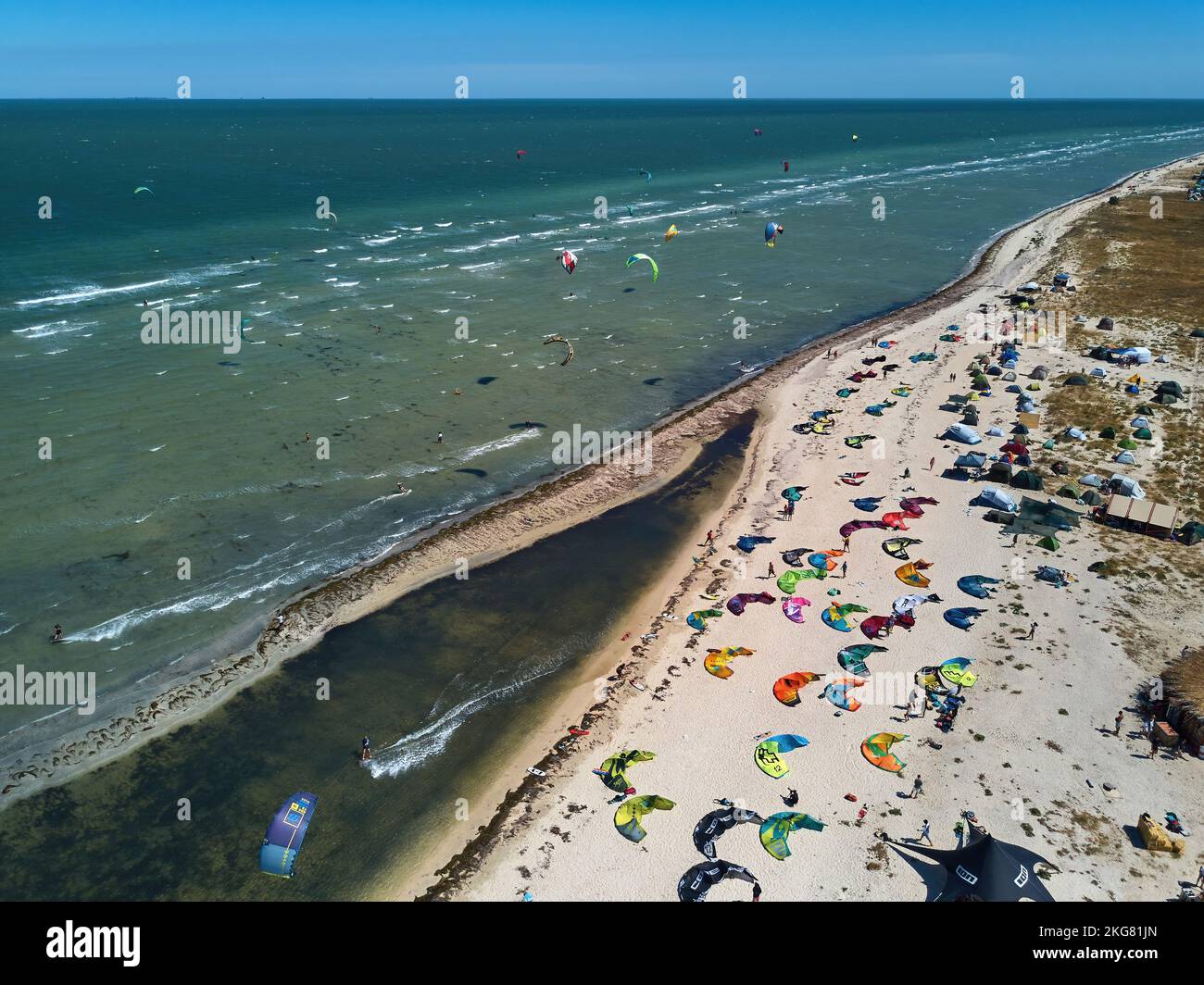 View from above of bright colorful kites lying parked on beach on windy ...