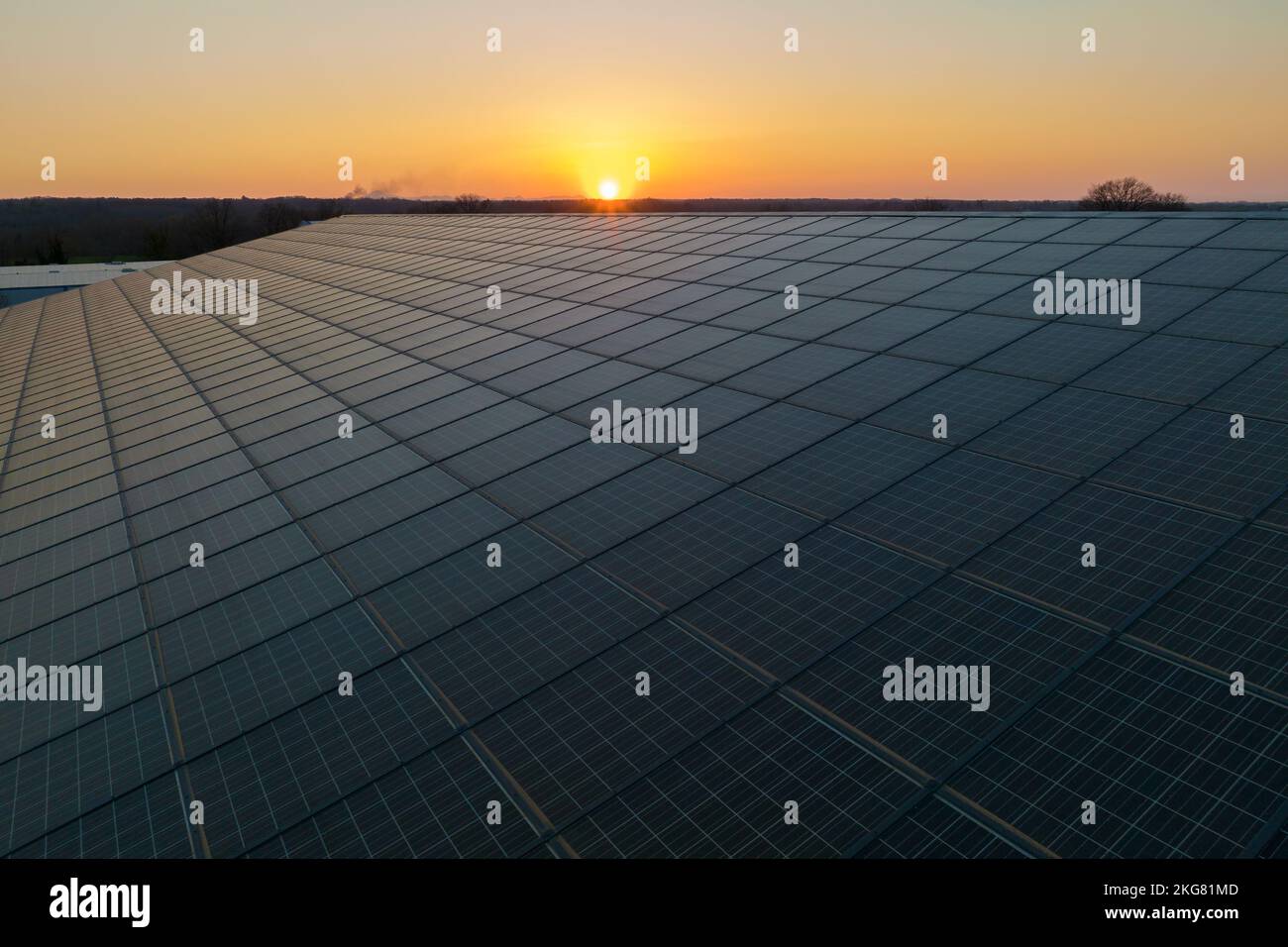 Aerial view of blue photovoltaic solar panels mounted on industrial ...
