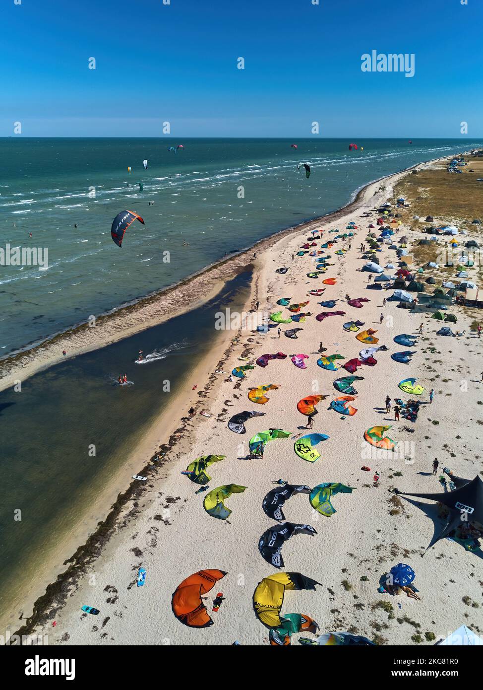 View from above of bright colorful kites lying parked on beach on windy ...