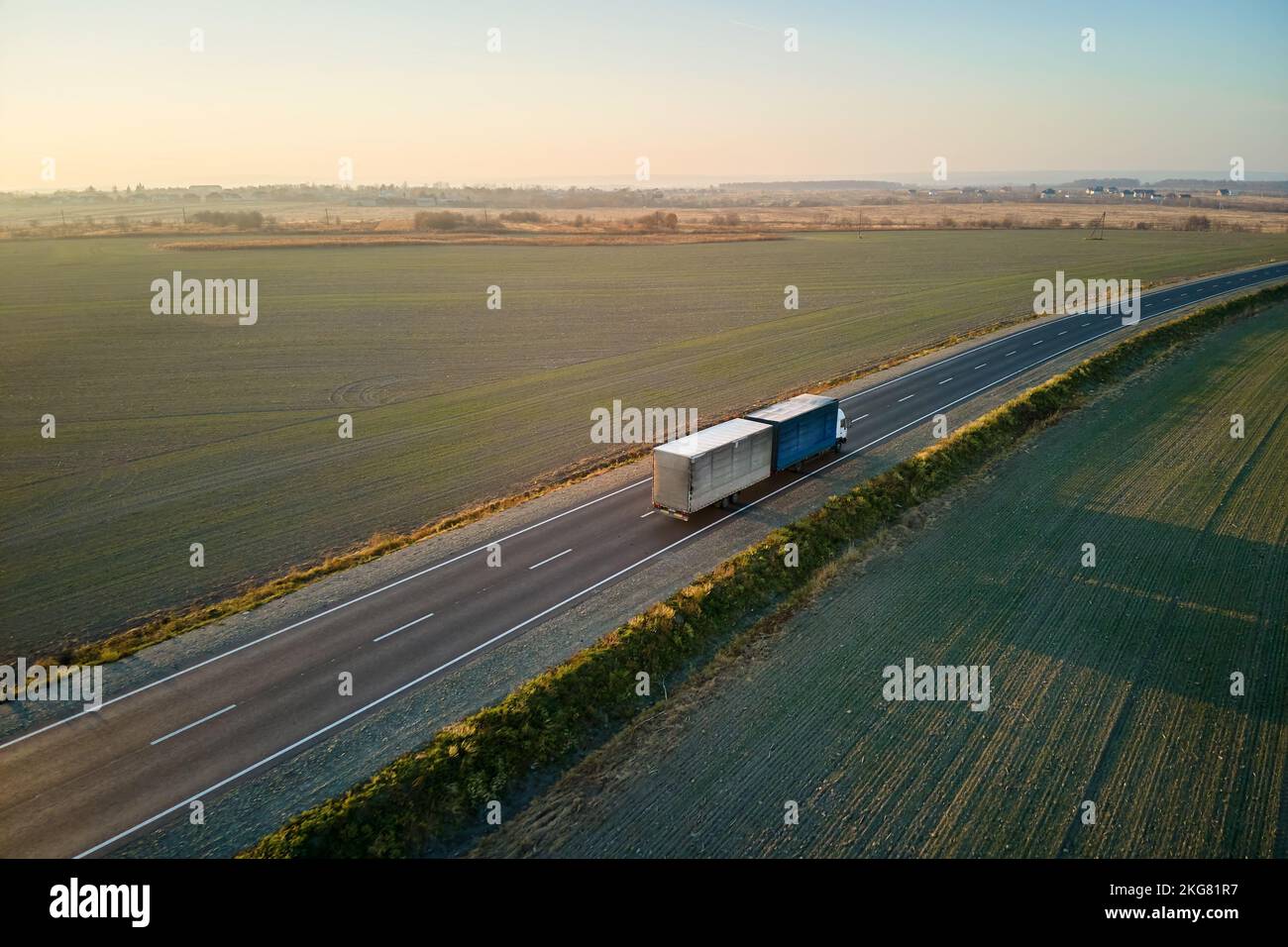 Aerial view of blurred fast moving semi-truck with cargo trailer ...