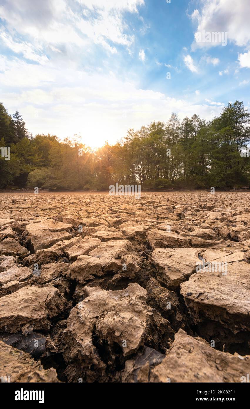 Dry riverbed with cracked mud in hot summer Stock Photo - Alamy