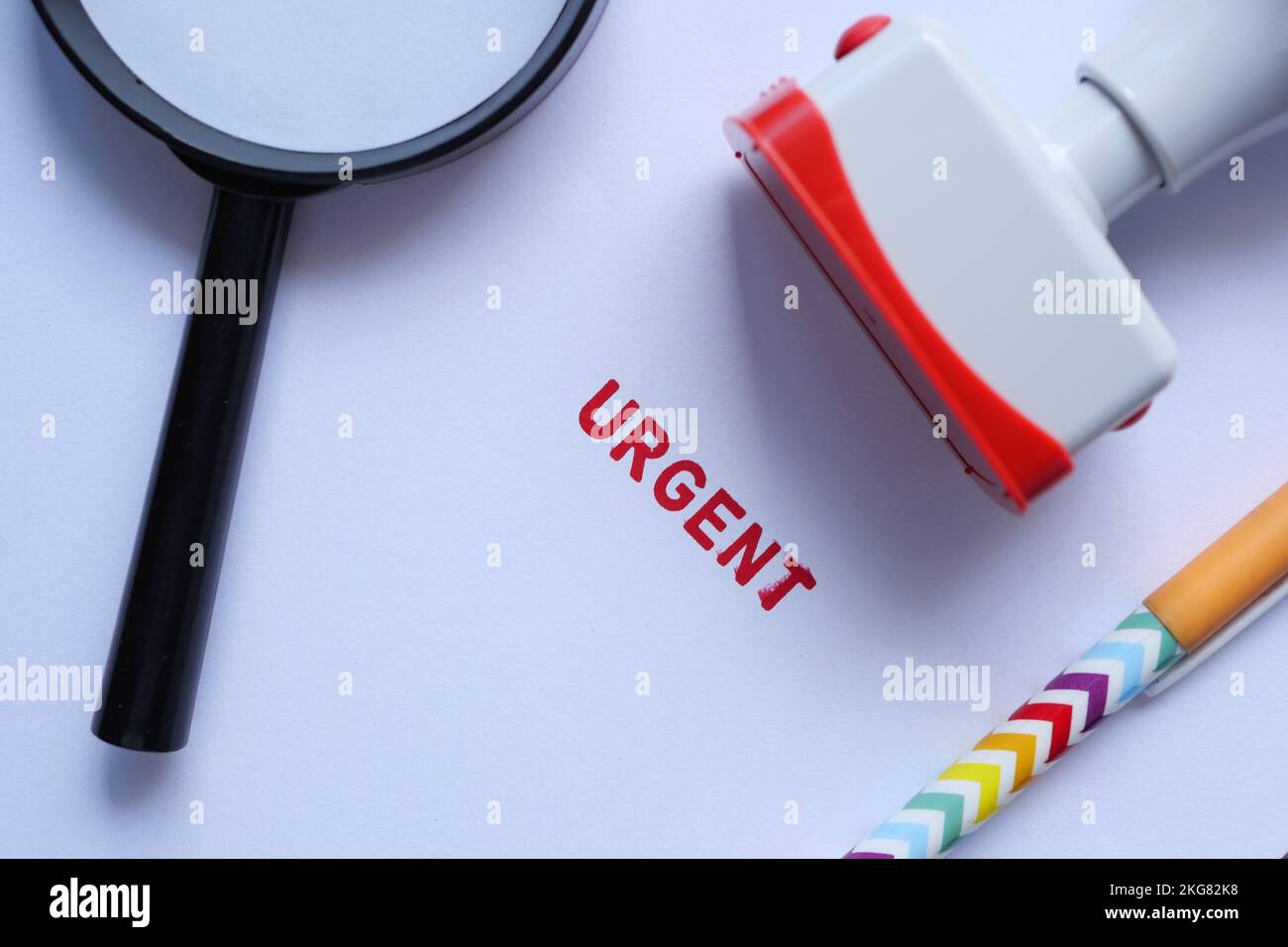 Red URGENT word stamp on a white paper Stock Photo - Alamy