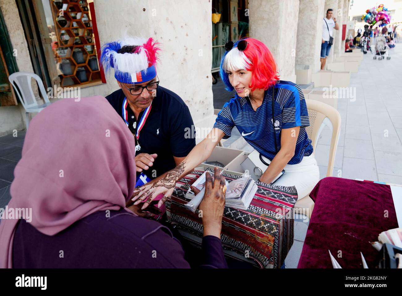 A French football fan receives a henna tattoo in the Souq Waqif, Doha ...