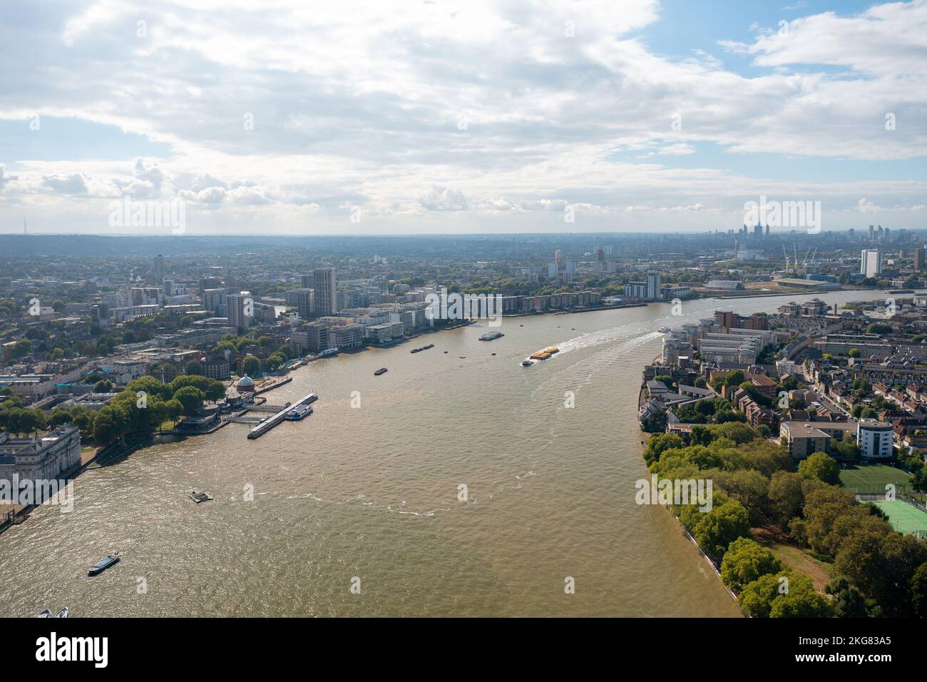 Thames river traffic in London, Cory tug towing barges of lemon-yellow ...
