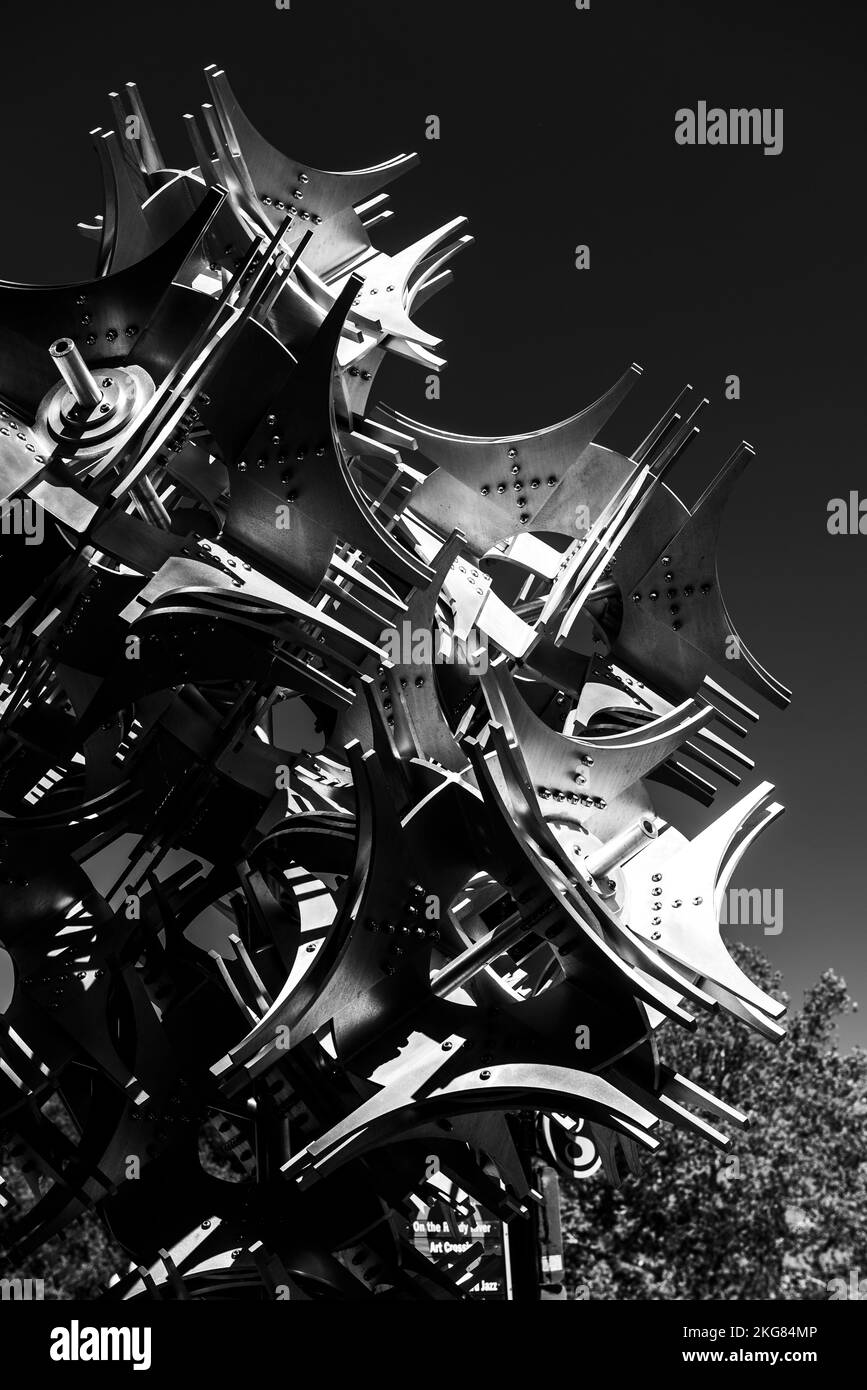 A vertical grayscale shot of a modern abstract sculpture in Greenville ...