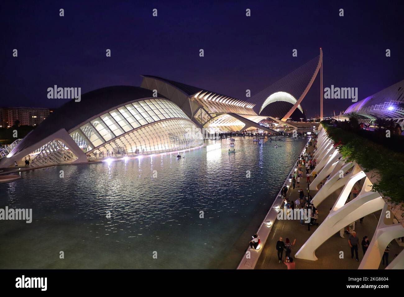 A night view of the city of Valencia with a water canal and modern ...